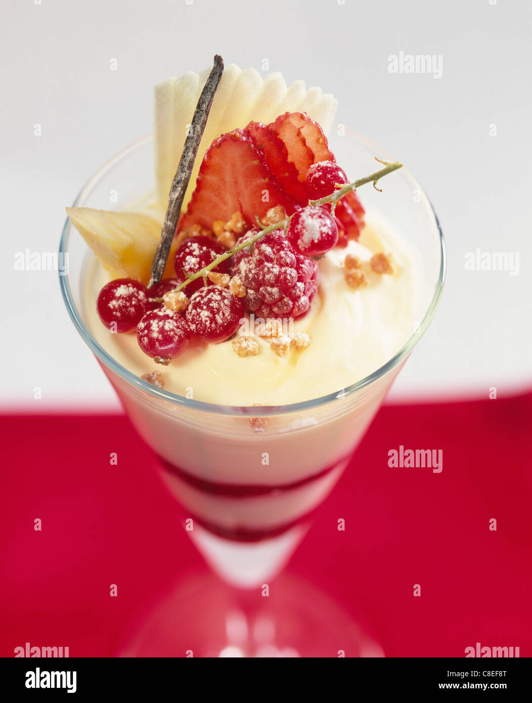 Pineapple cream dessert with summer fruit puree Stock Photo - Alamy