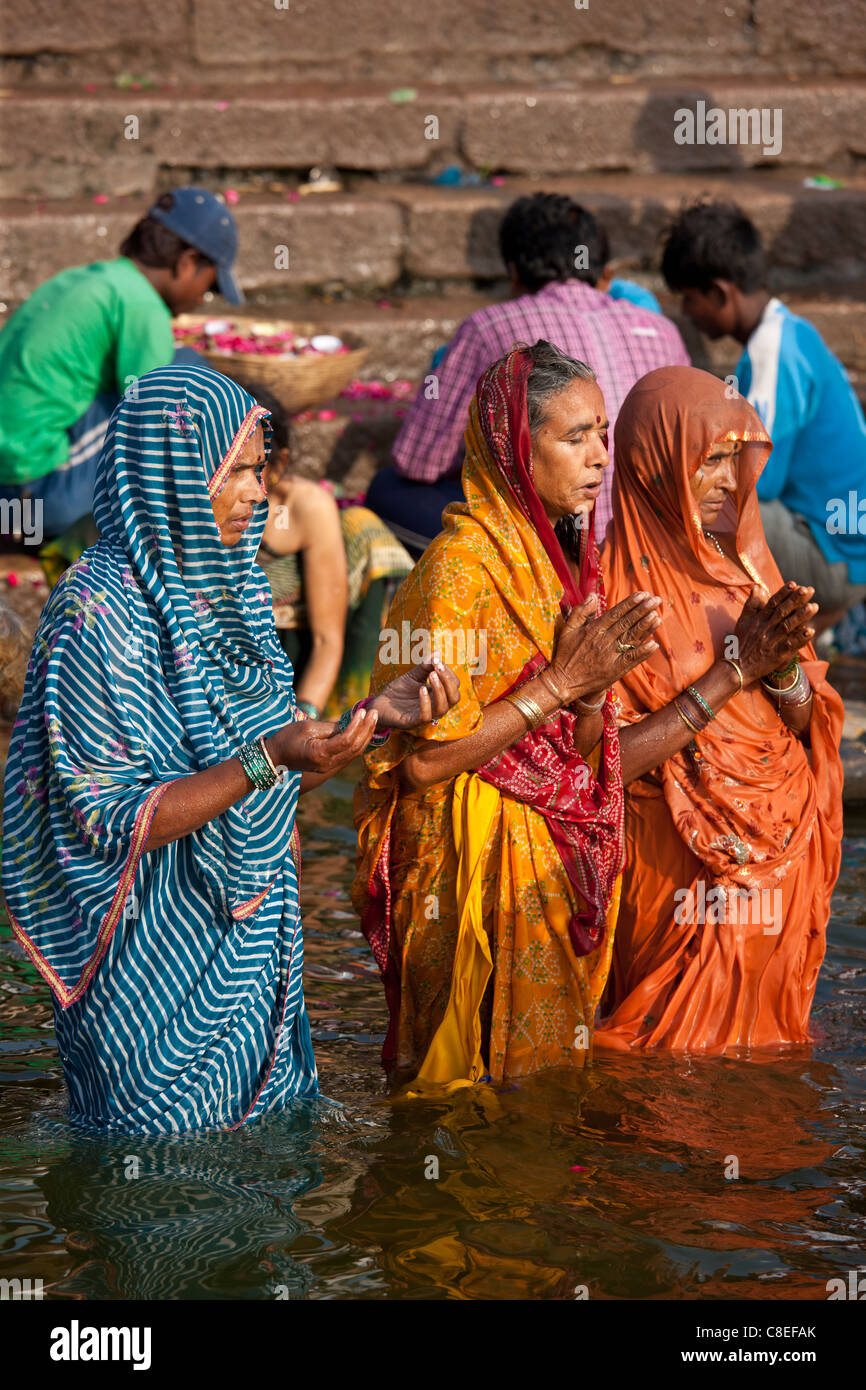 Indian Hindu pilgrims bathing and praying in The Ganges River at ...