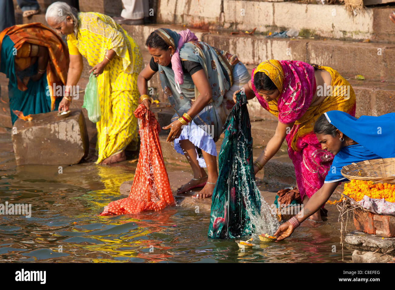 Indian Hindu pilgrims washing clothes and bathing in The Ganges River ...