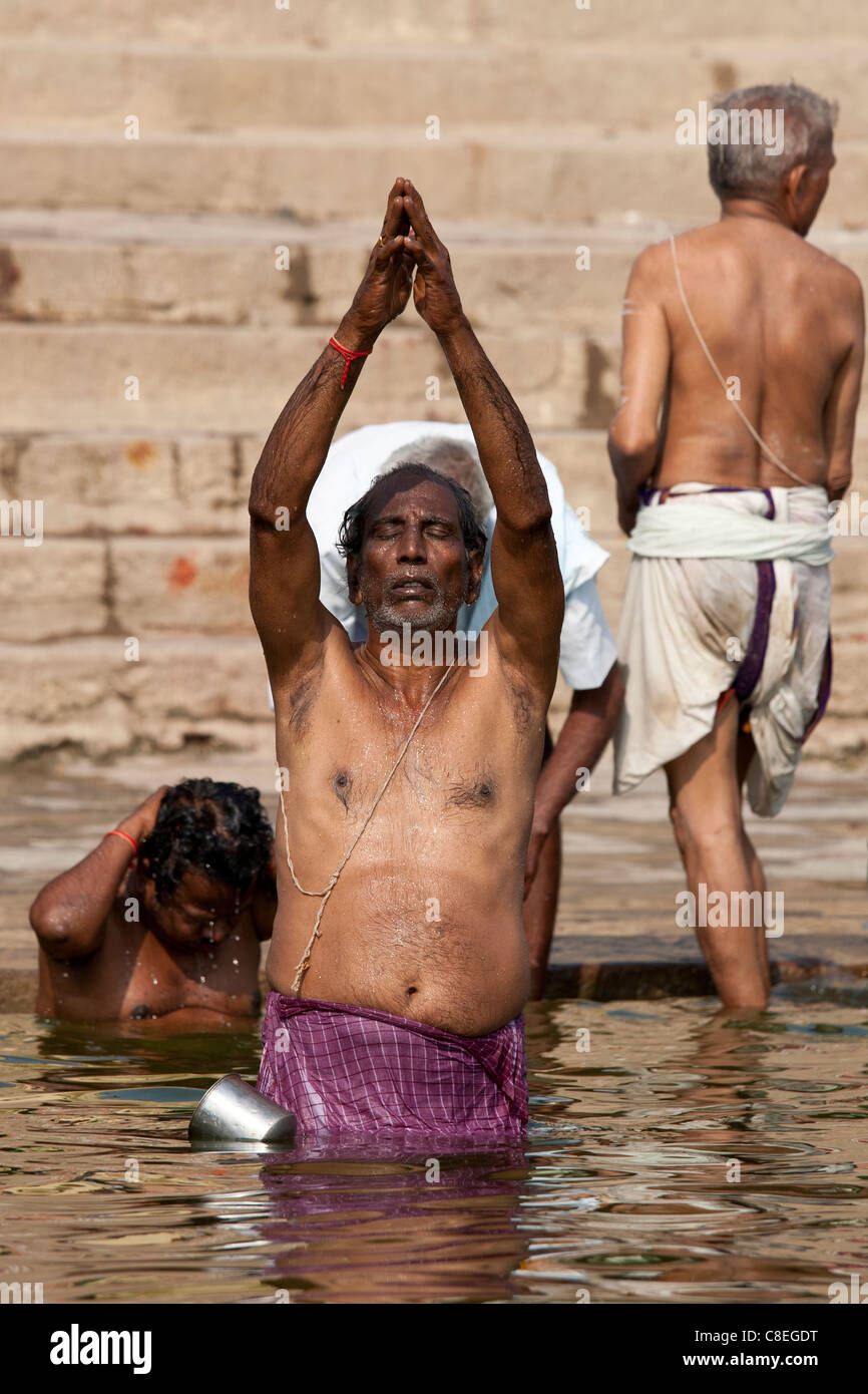 Indian Hindu man bathing and praying in the River Ganges by Kshameshwar ...