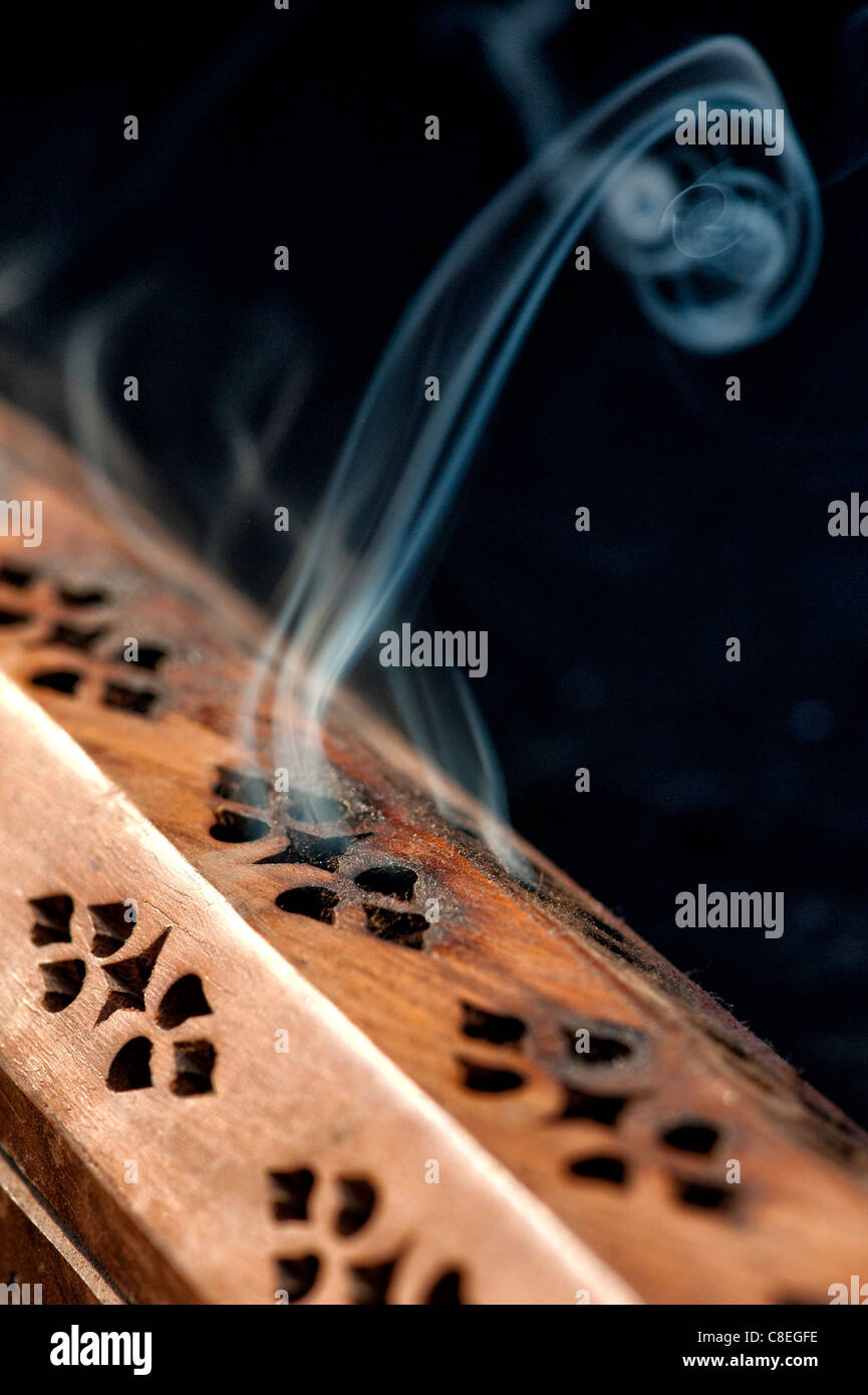 Incense smoke coming from wooden incense burner Stock Photo - Alamy