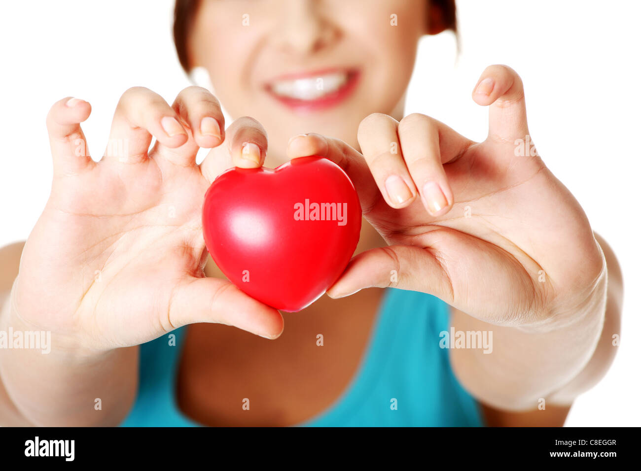 Pretty teen girl showing red heart in her hand over white Stock Photo ...