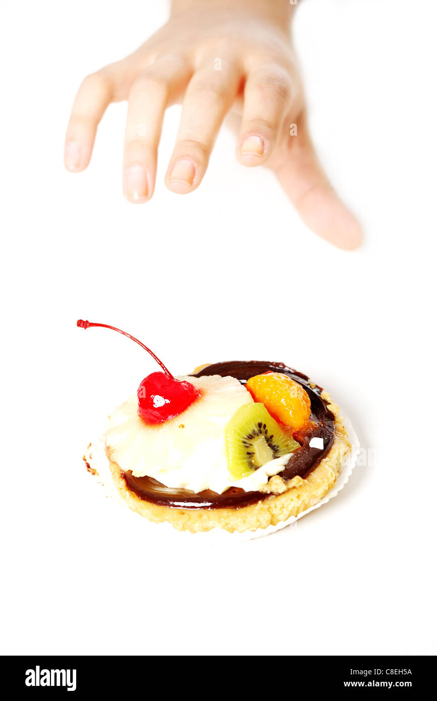 Hand reaching for a cake over white background Stock Photo - Alamy