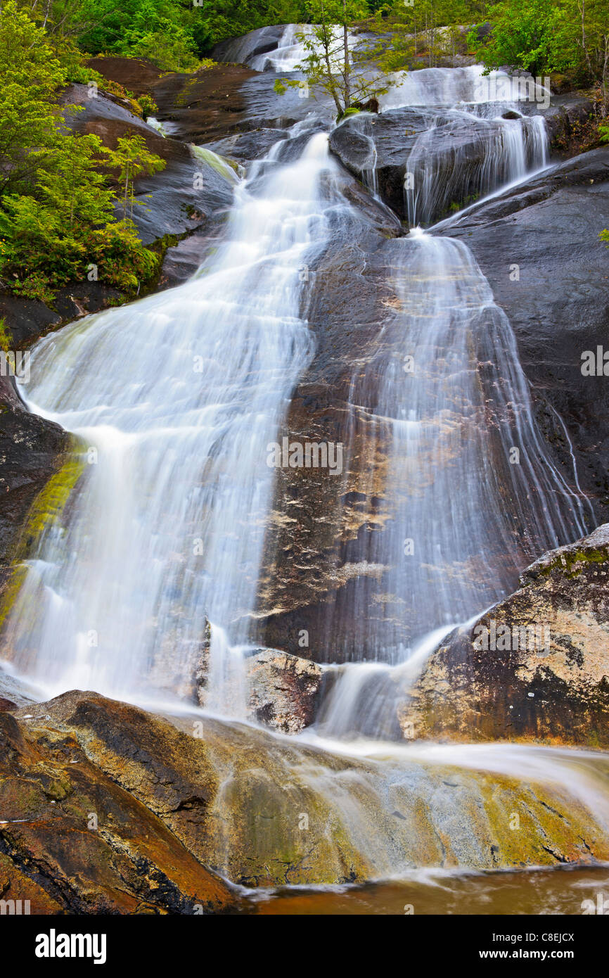 Noname waterfall running down on the hard rock of a mountain right into ...