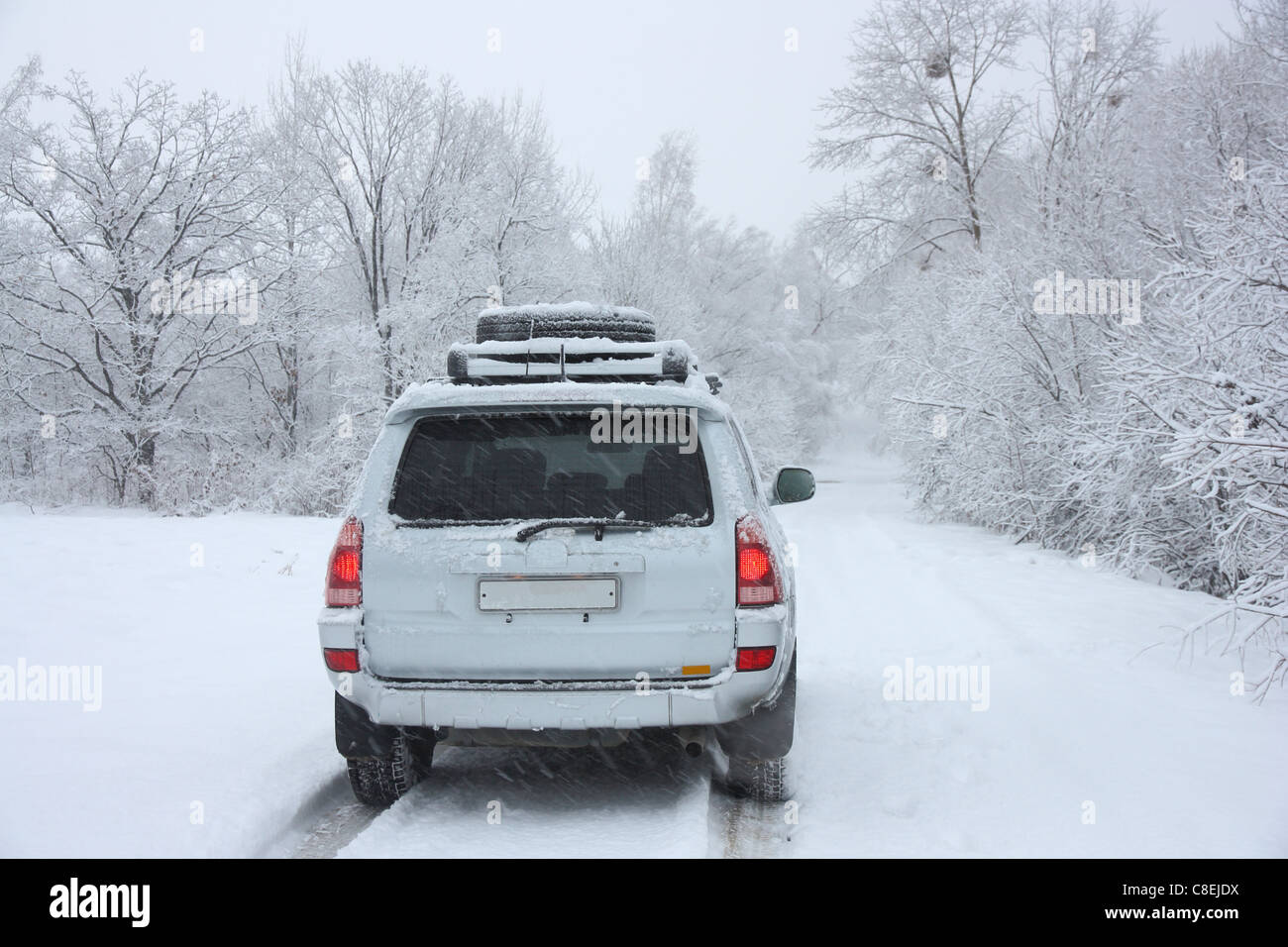 Snowy winter road behind an unrecognizable car Stock Photo - Alamy