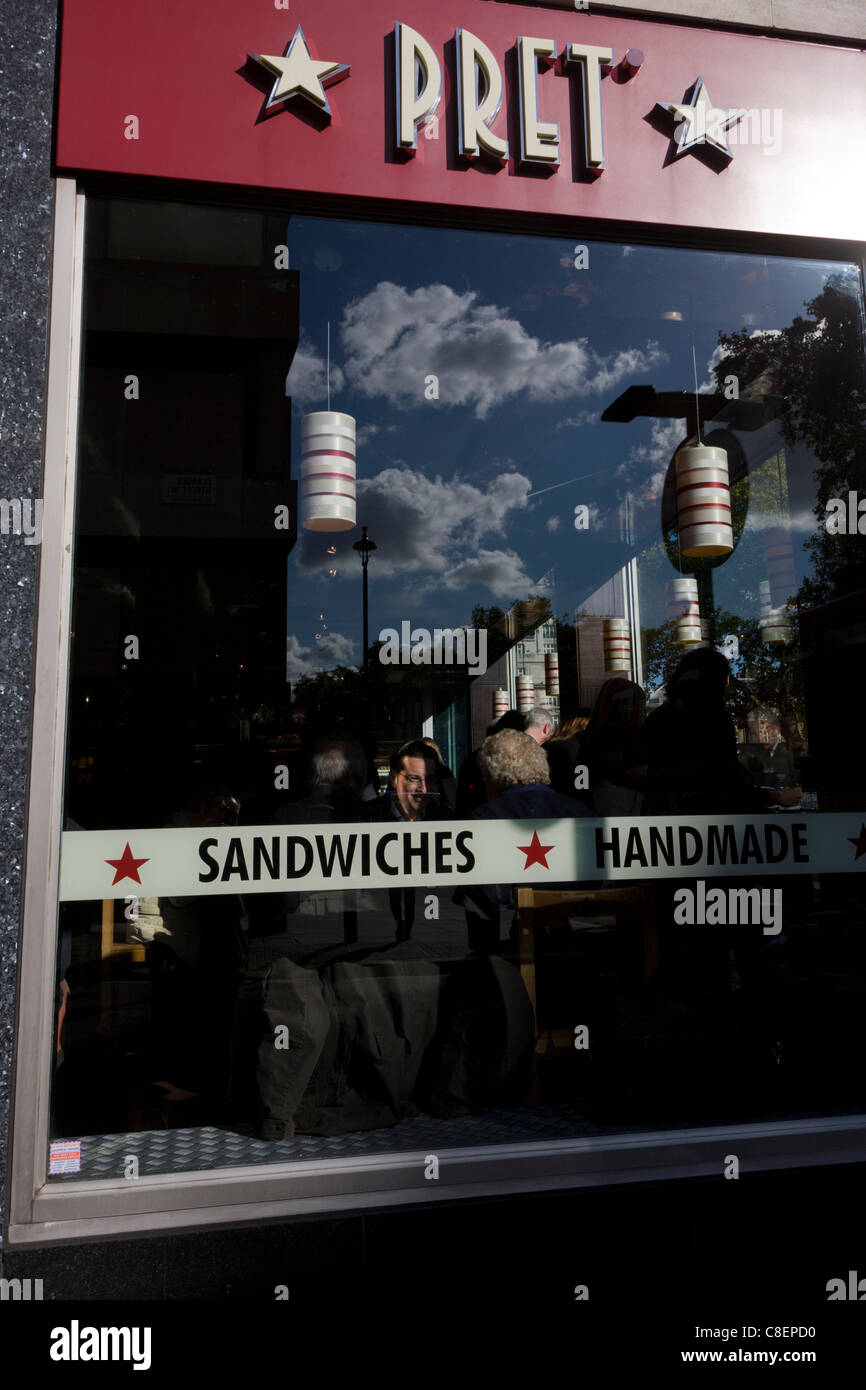 Lunchtime diners see through a window of successful sandwich chain Pret ...