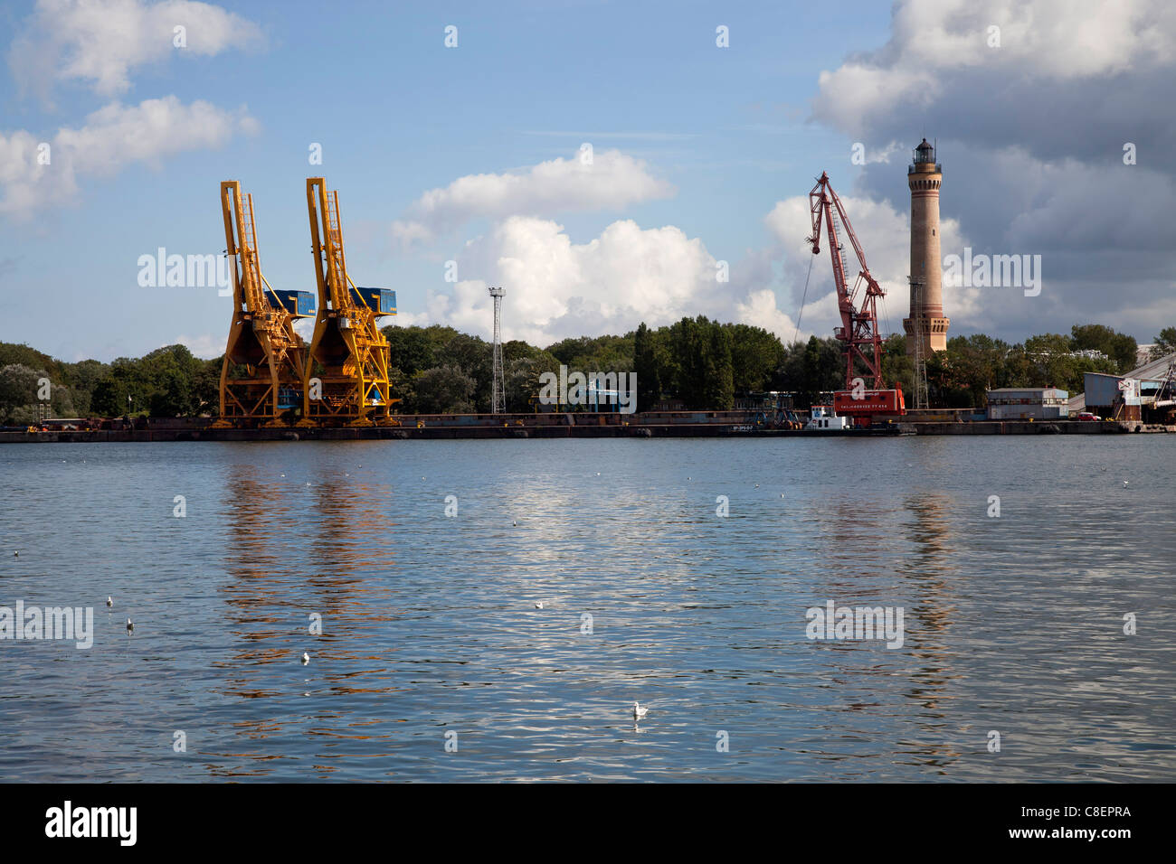 harbour cranes and the highest lighthouse at the baltic sea at ...