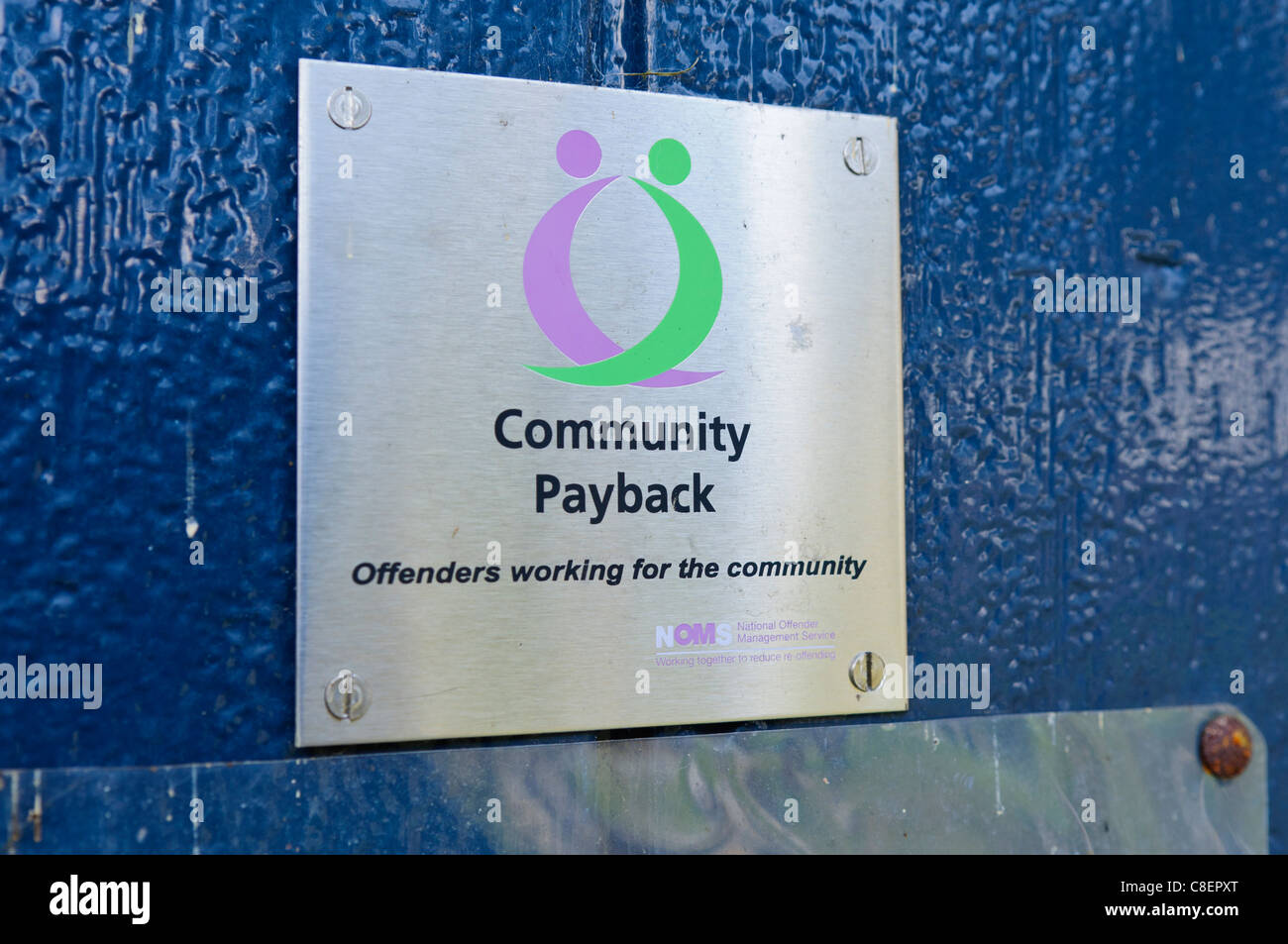 Community Payback sign Stock Photo - Alamy