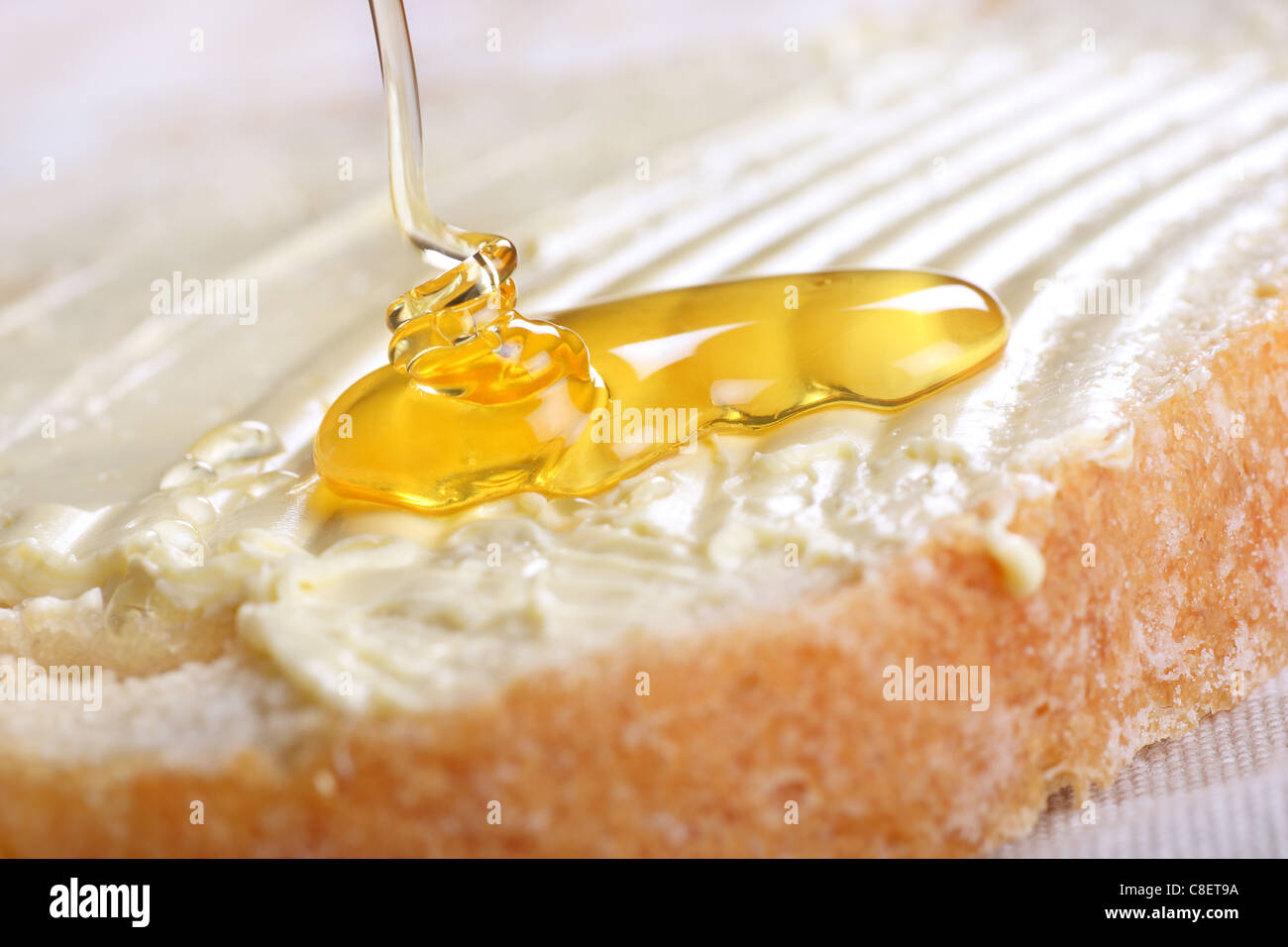 freshly made bread with butter and runny sweet syrup Stock Photo - Alamy