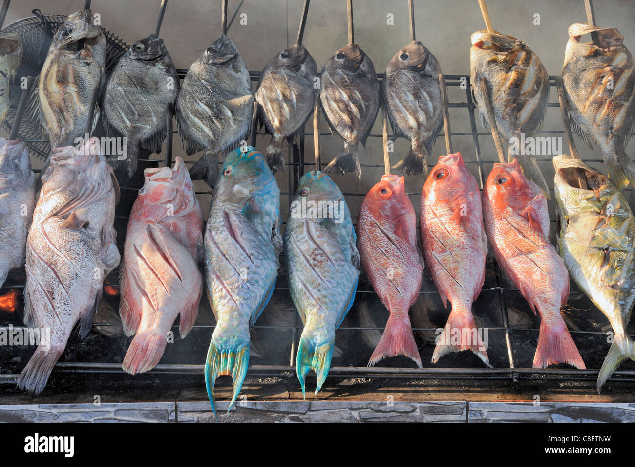 Colored reef fish on an indonesian barbecue Stock Photo - Alamy
