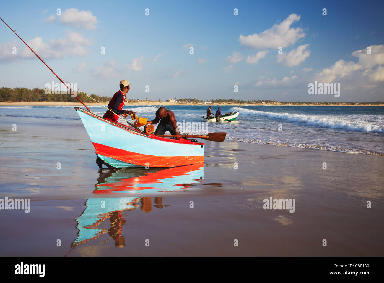 Fishermen launching fishing boats on Tofo beach, Tofo, Inhambane ...