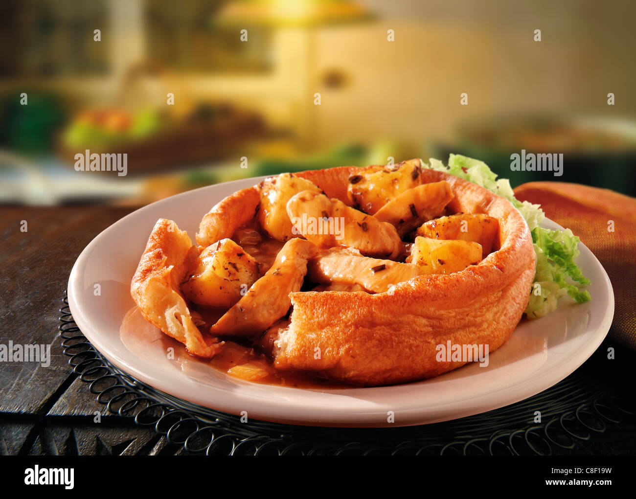 Traditional giant yorkshire pudding with chicken casserole served on a ...