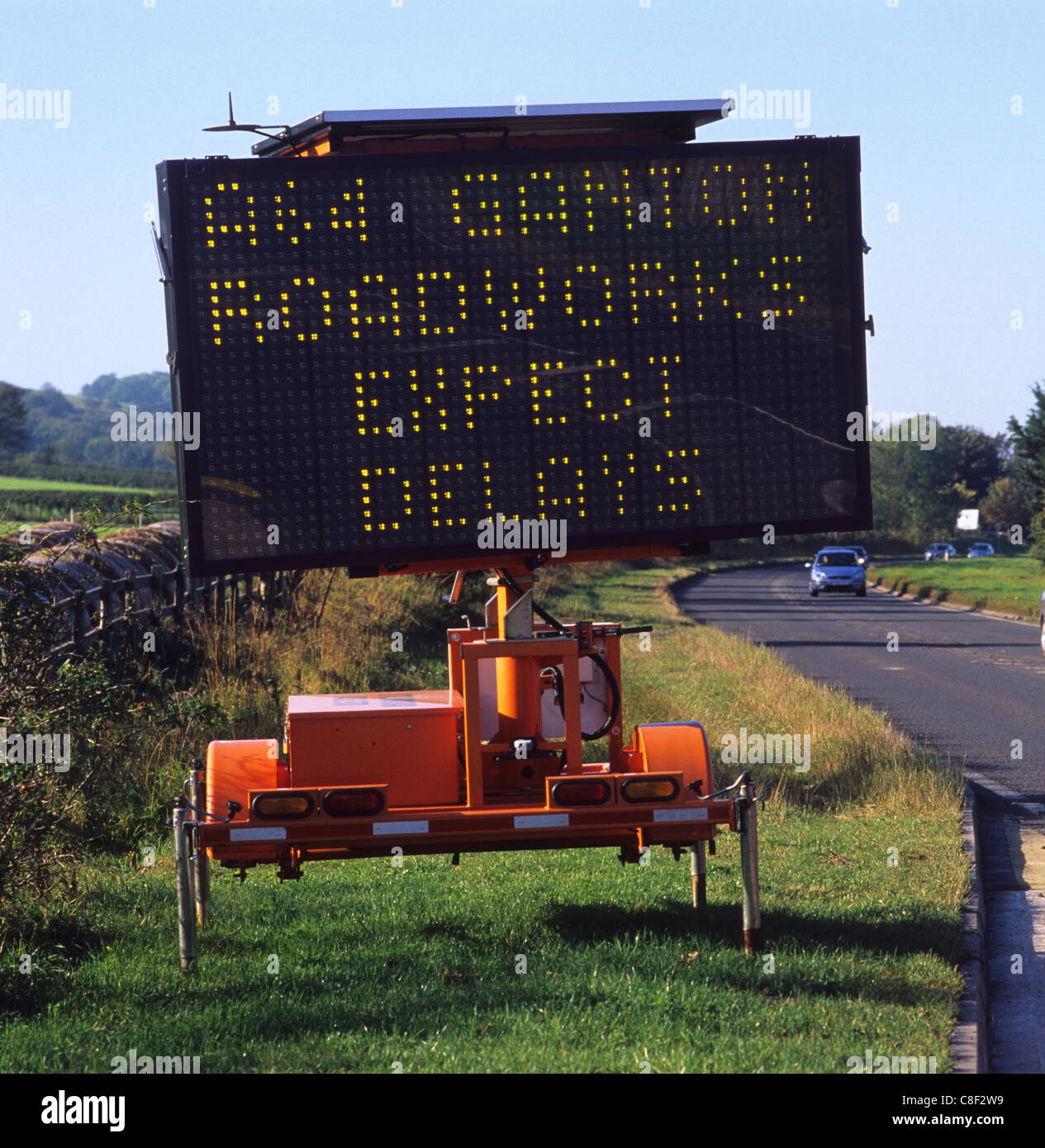 roadside electronic warning sign of roadworks and delays on road ahead ...