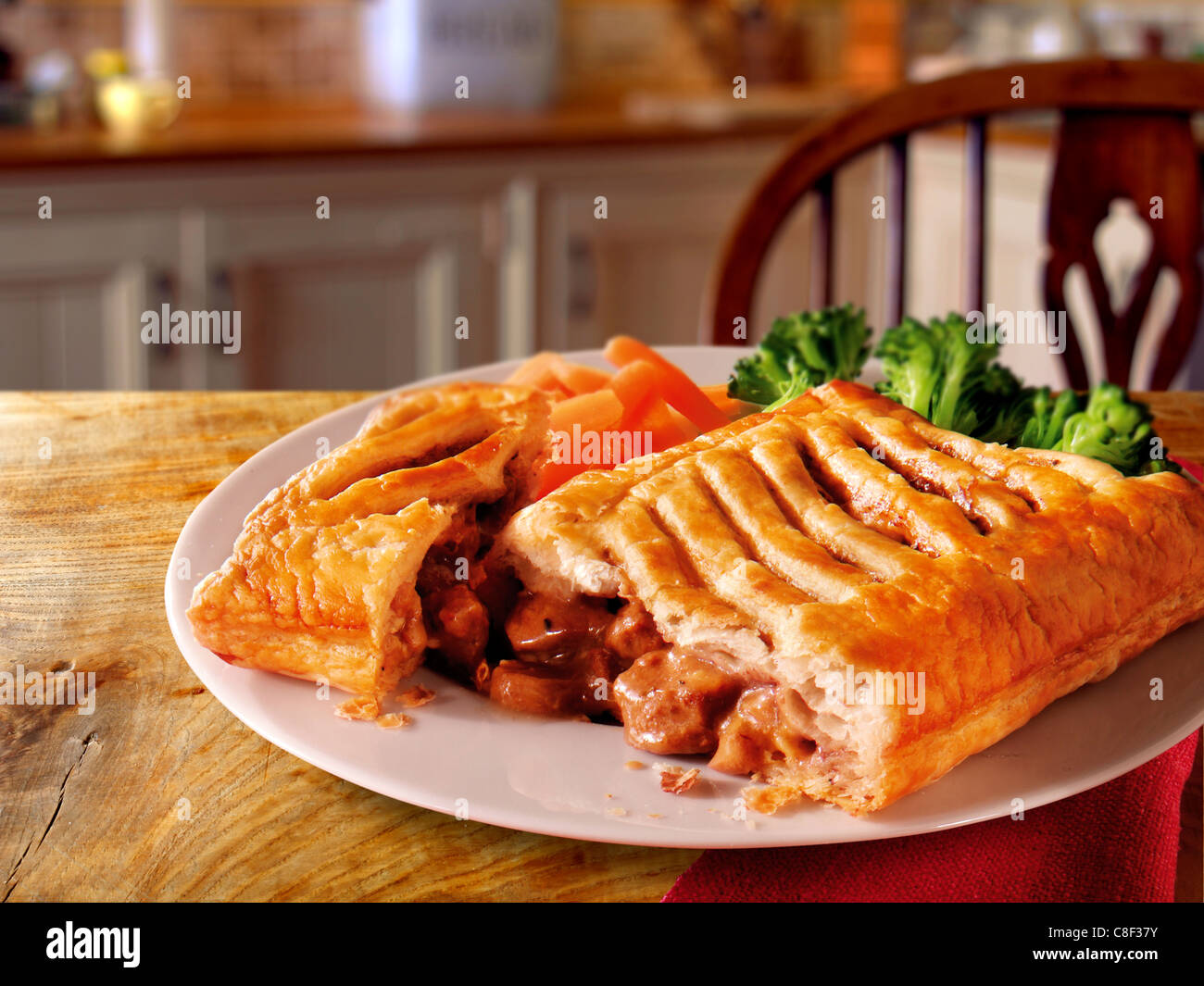Traditional peppered steak lattice pie meal served with roast potatoes ...