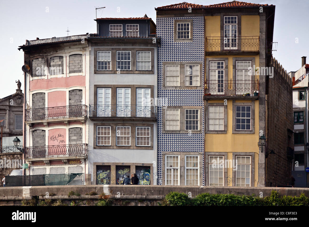 Porto, traditional buildings by the River Douro with two people and ...