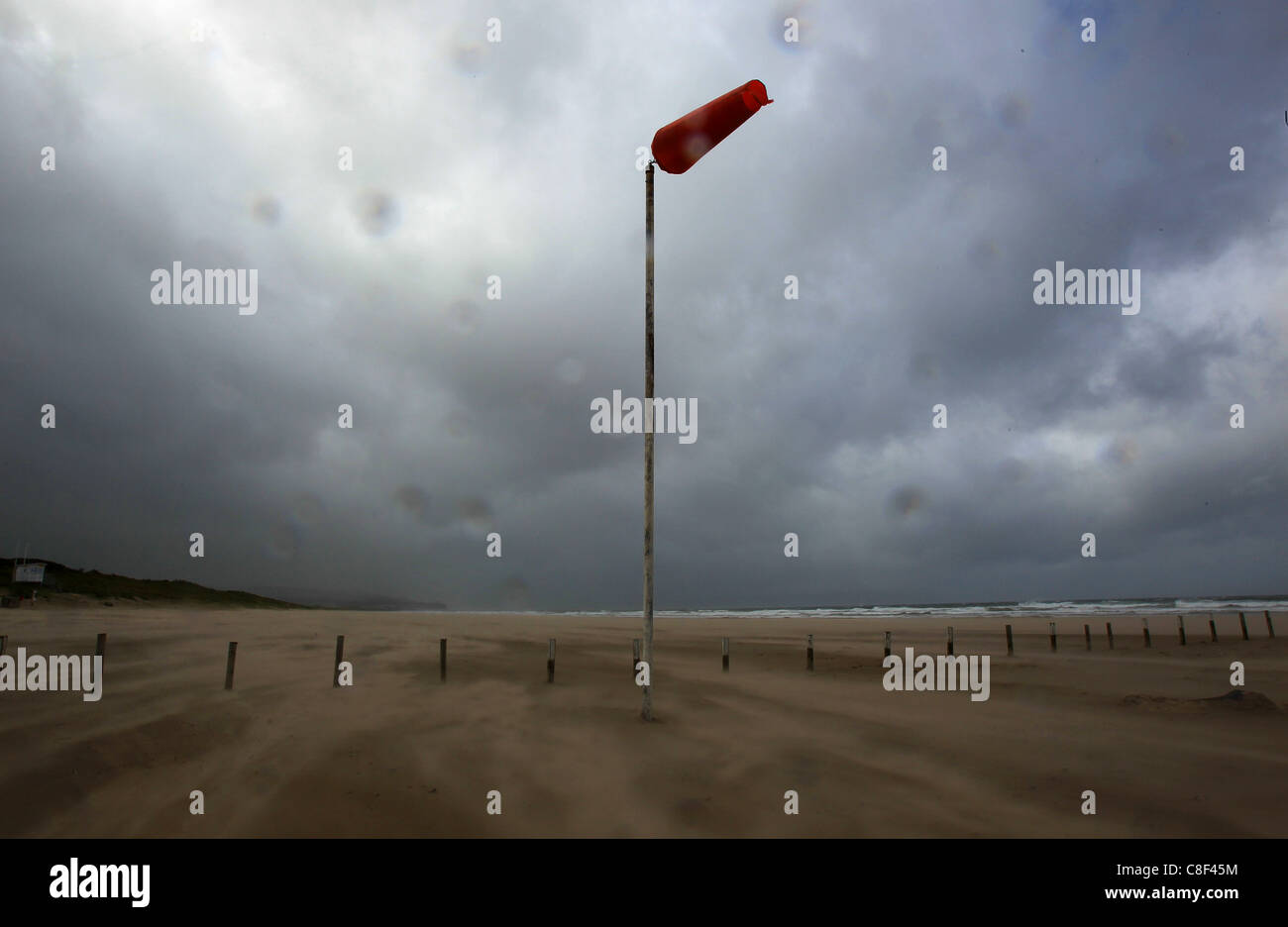 A wind sock and sand blow along Portstewart Strand beach in Portstewart ...