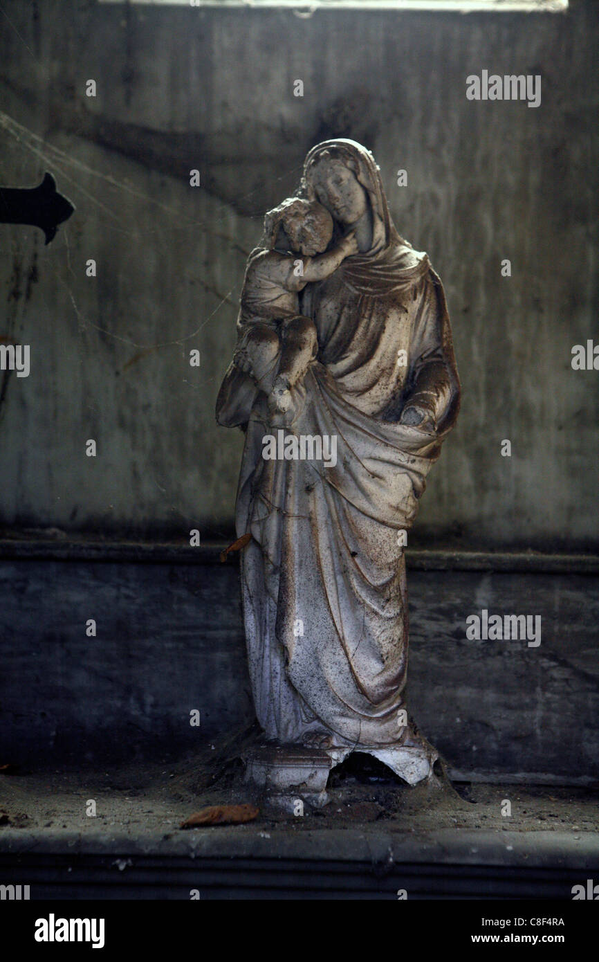 old statuette of Madonna & child baby Jesus, with cob webs, inside a ...