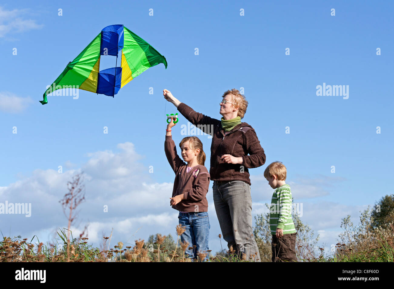 family flying a kite Stock Photo - Alamy