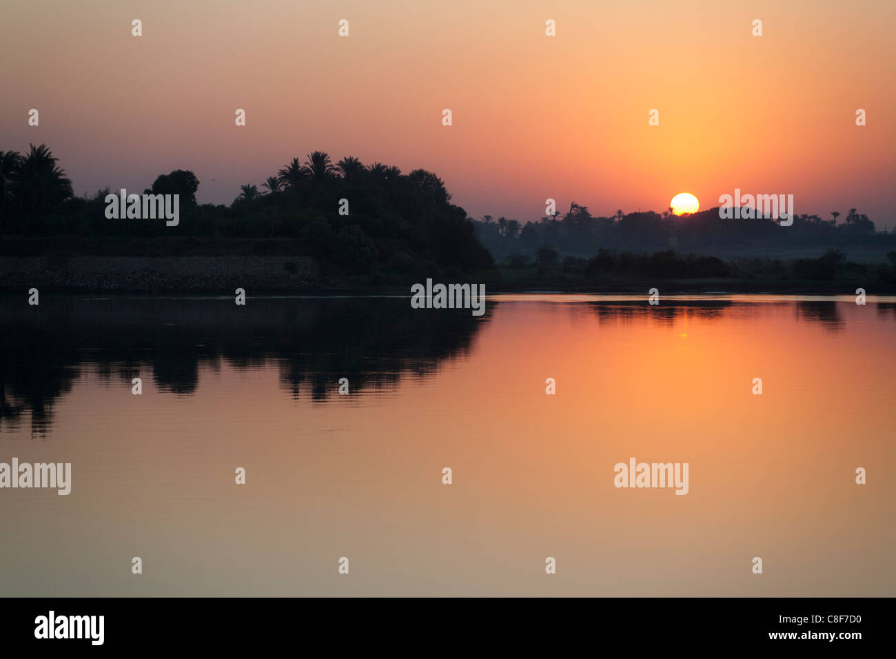 Golden sun disc reflected in the river nile at sunrise hi-res stock ...