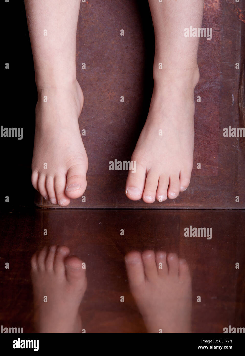 A cute symbolic image of two feet and there reflection Stock Photo - Alamy