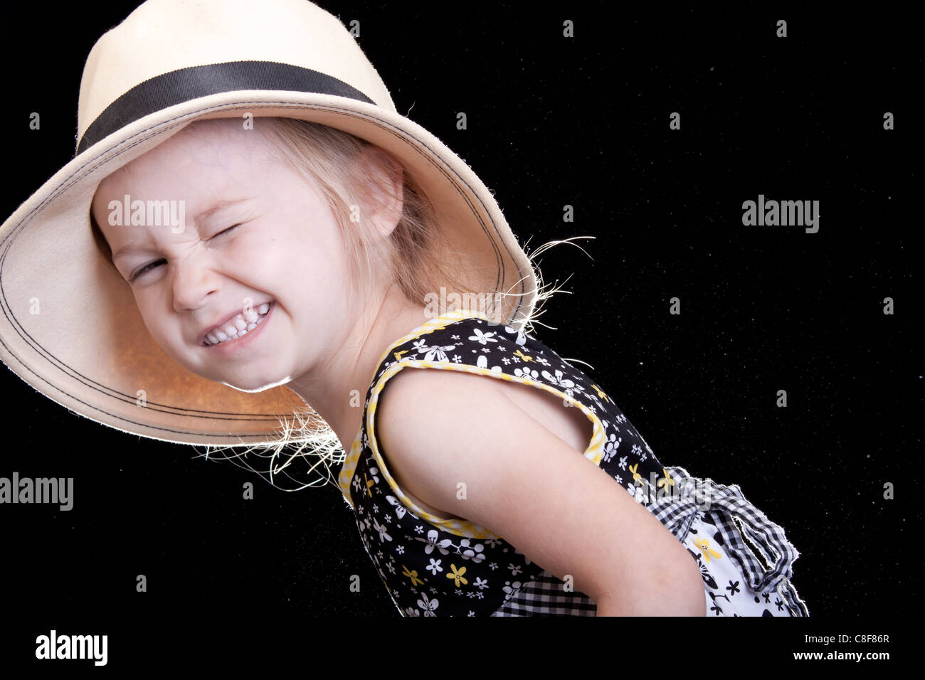 A cute rim lit image of a child winking. She is coming from outer space ...