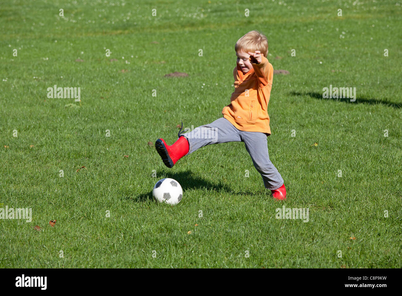 young boy playing football Stock Photo - Alamy
