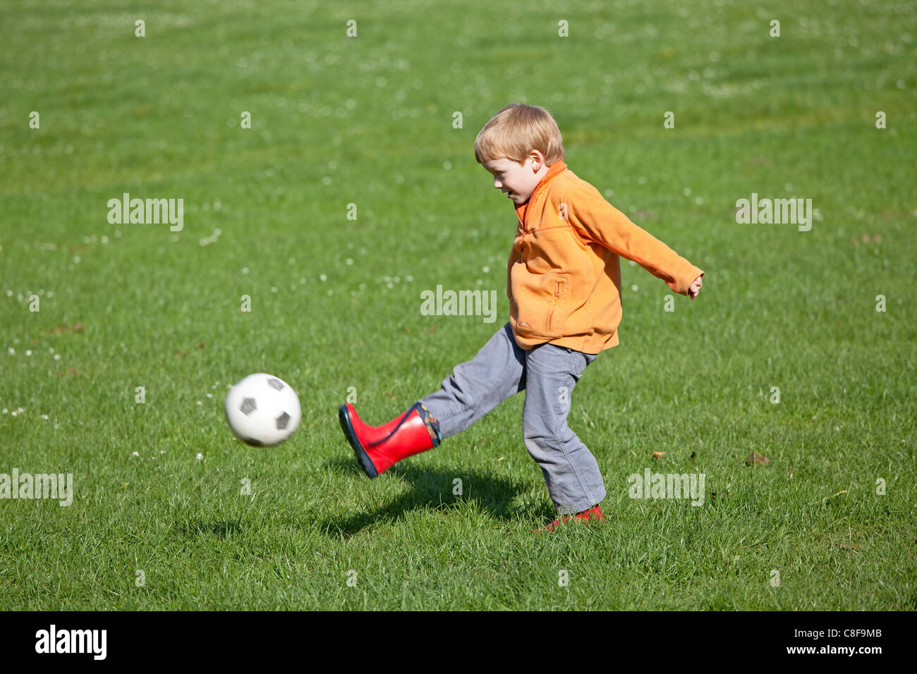 young boy playing football Stock Photo - Alamy young boy playing football Stock Photo - Alamy