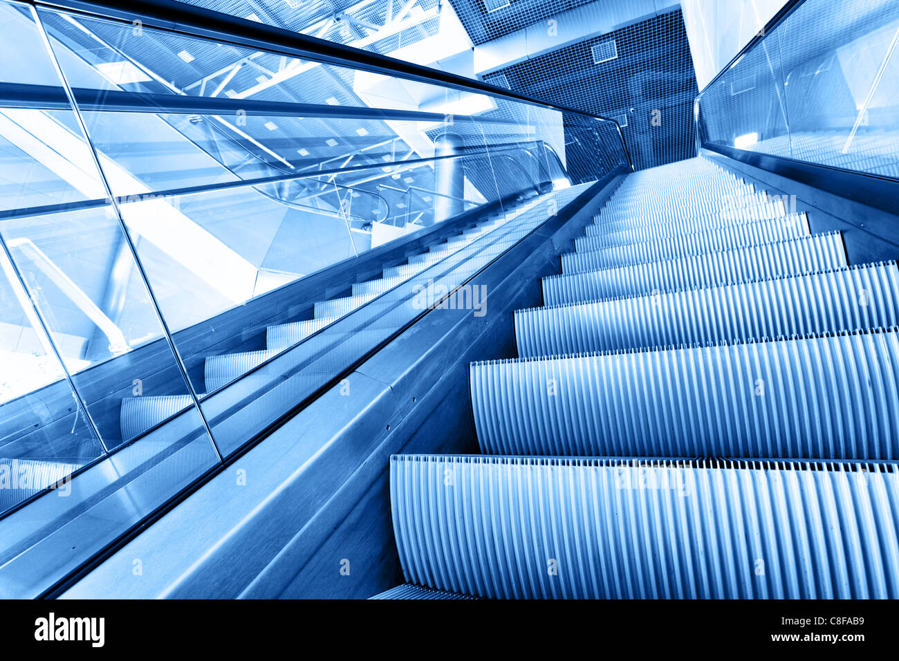 Perspective of escalator toned in blue color Stock Photo - Alamy