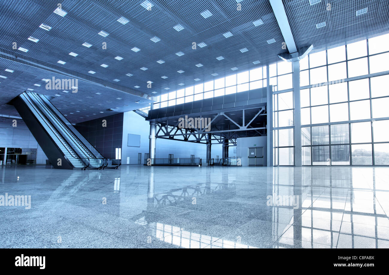 Large modern hall with windows and escalator Stock Photo - Alamy