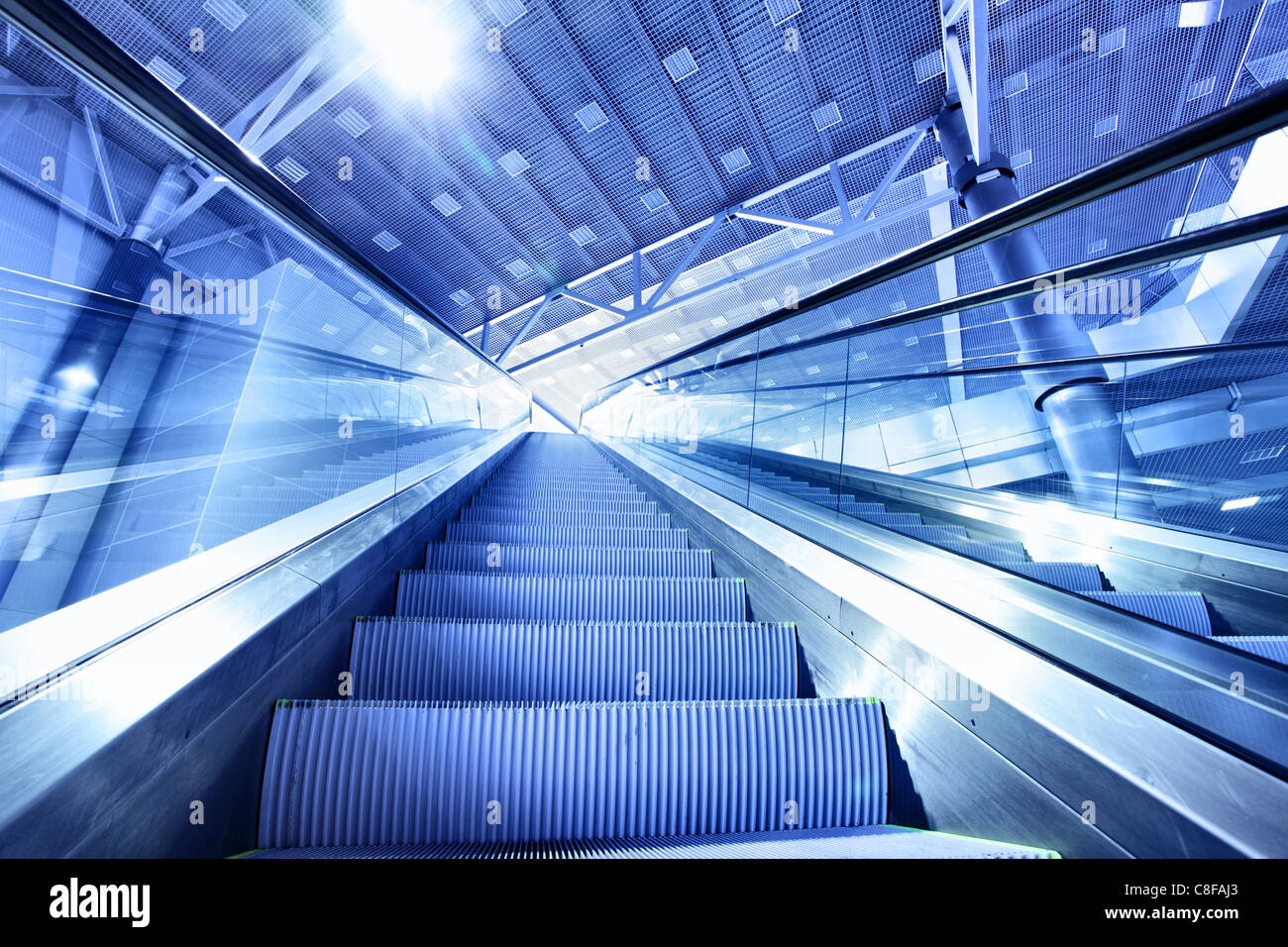 Perspective of escalator toned in blue color Stock Photo - Alamy
