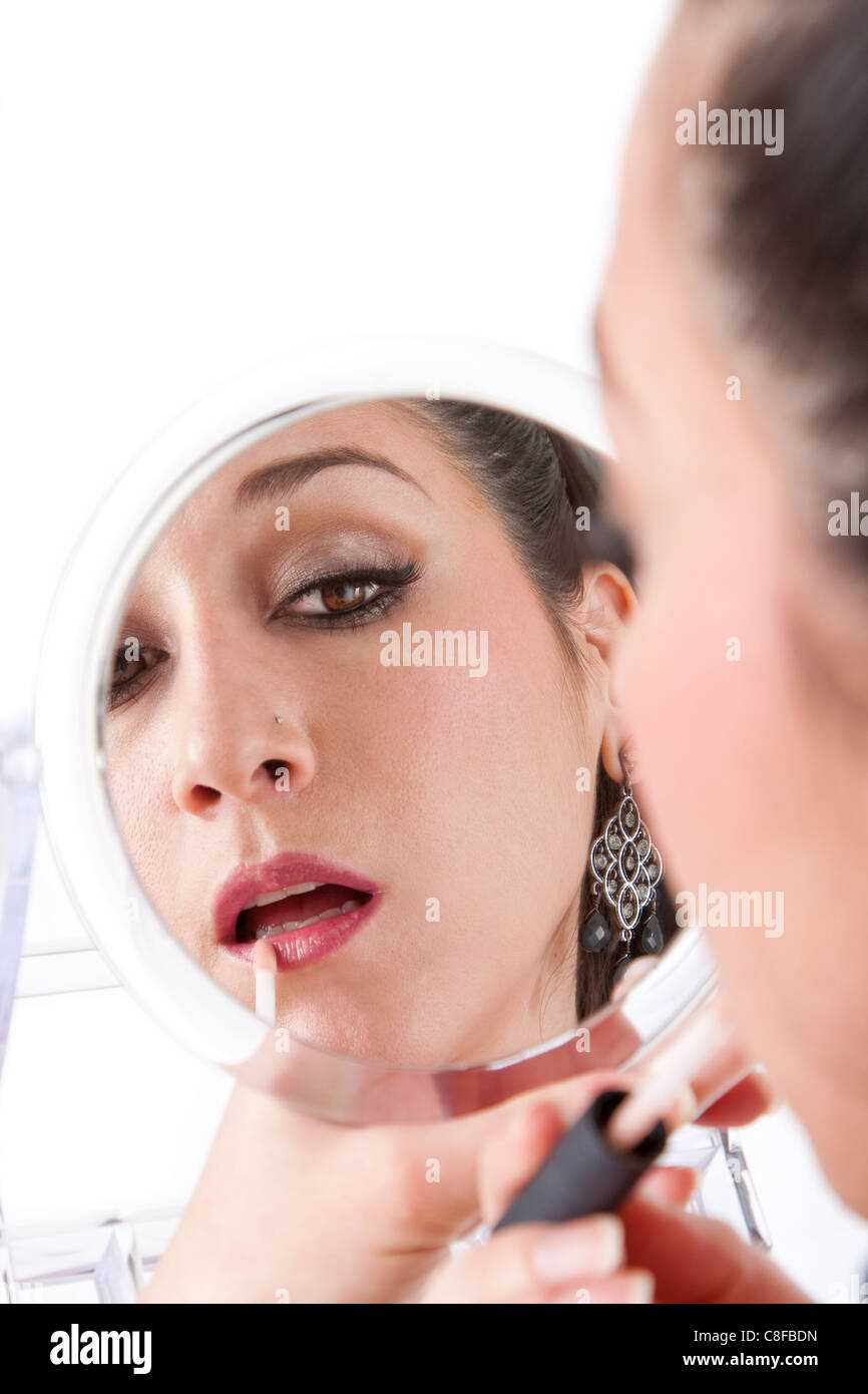 Woman applying makeup Stock Photo - Alamy