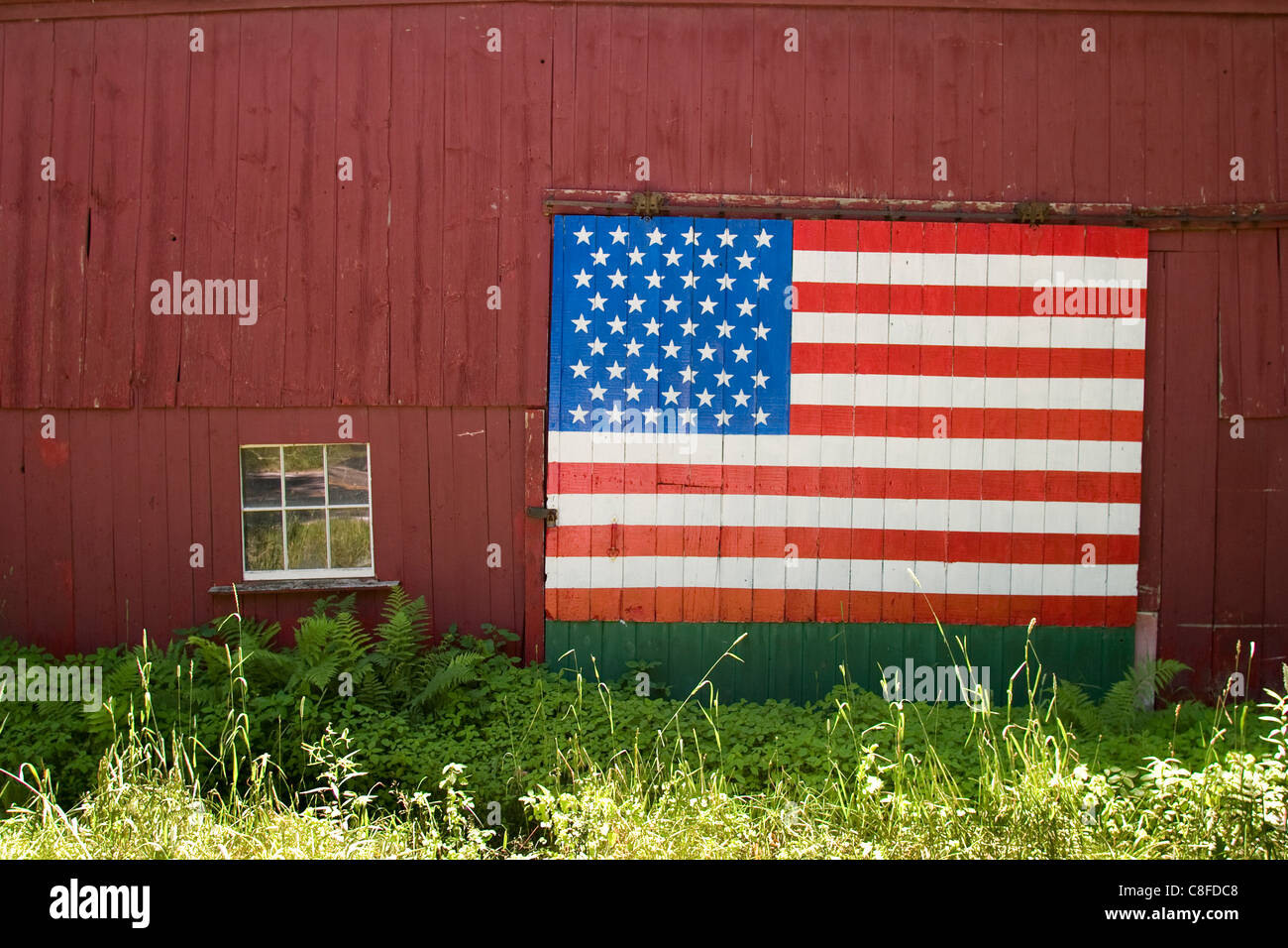 Red barn with American flag painted on the door in Hubbardston ...