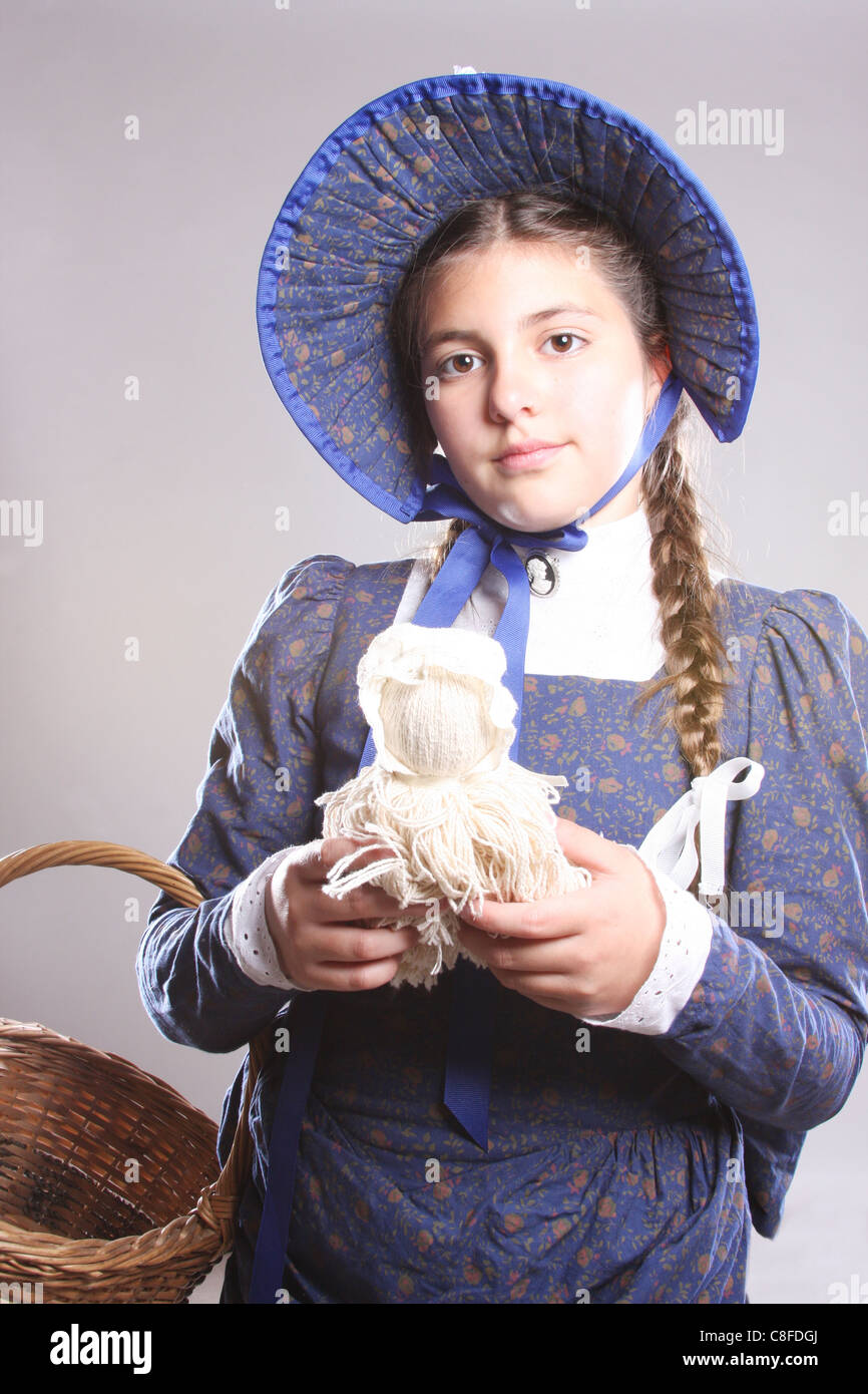 A victorian dressed girl with a toy string doll Stock Photo - Alamy