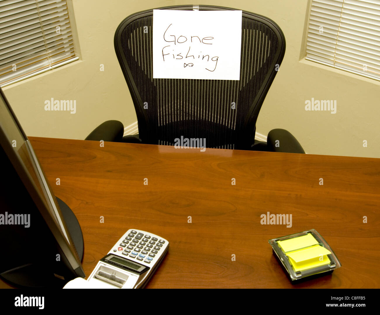Gone Fishing Sign at a Vacant Desk Stock Photo - Alamy