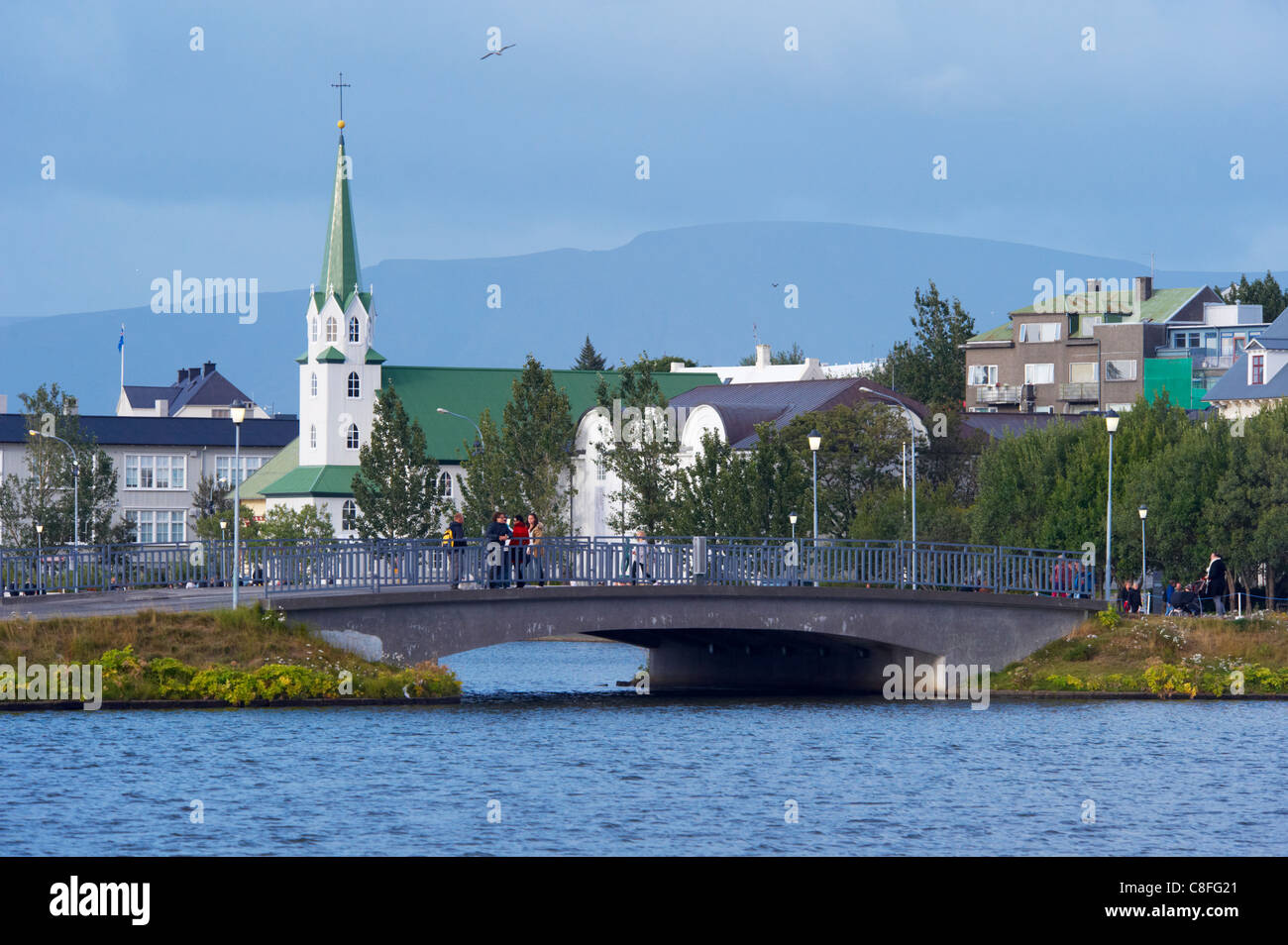 Lake Tjornin and Frikirkjan church in the center of old Reykjavik ...