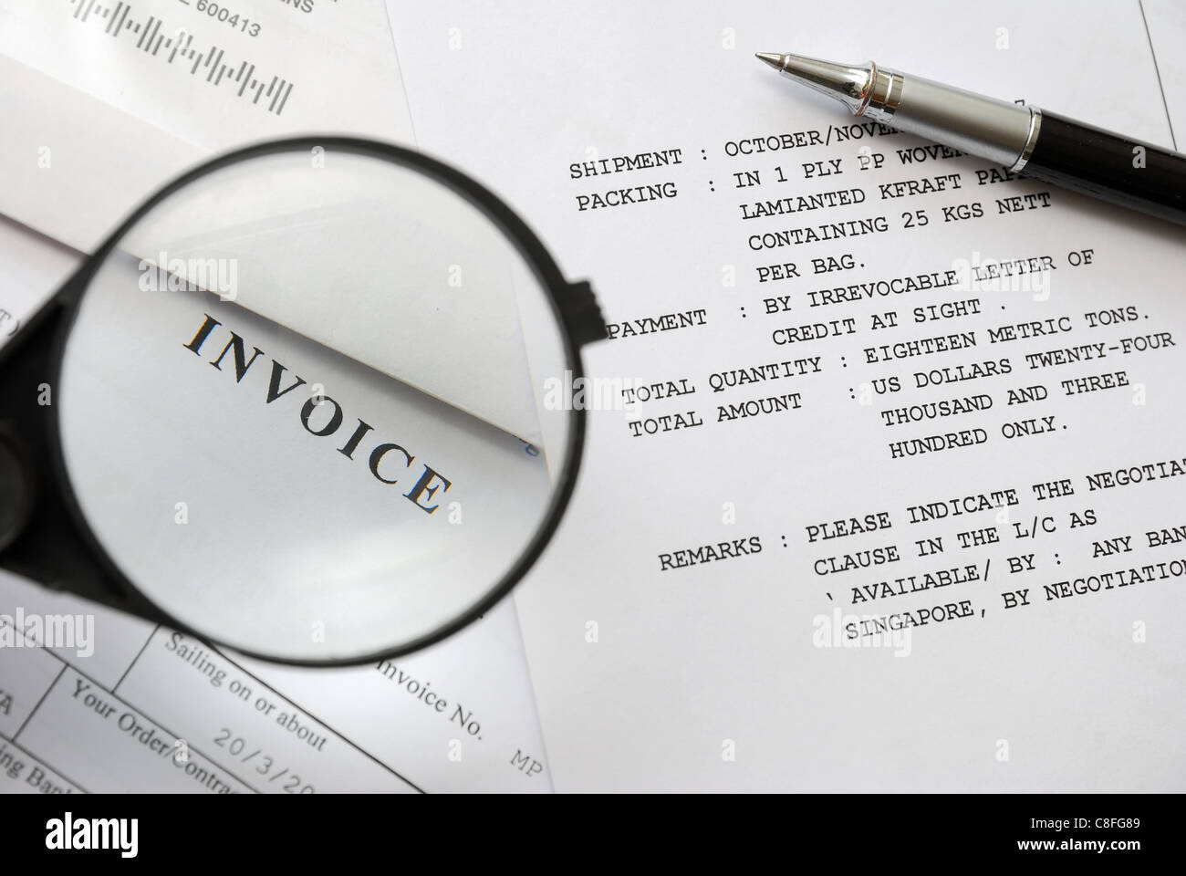 Magnifying glass on invoice word, signifying business and trading ...