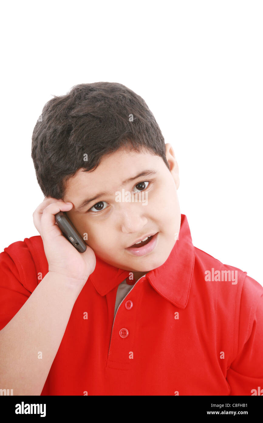 Young boy talking to cell phone, isolated on white background Stock ...