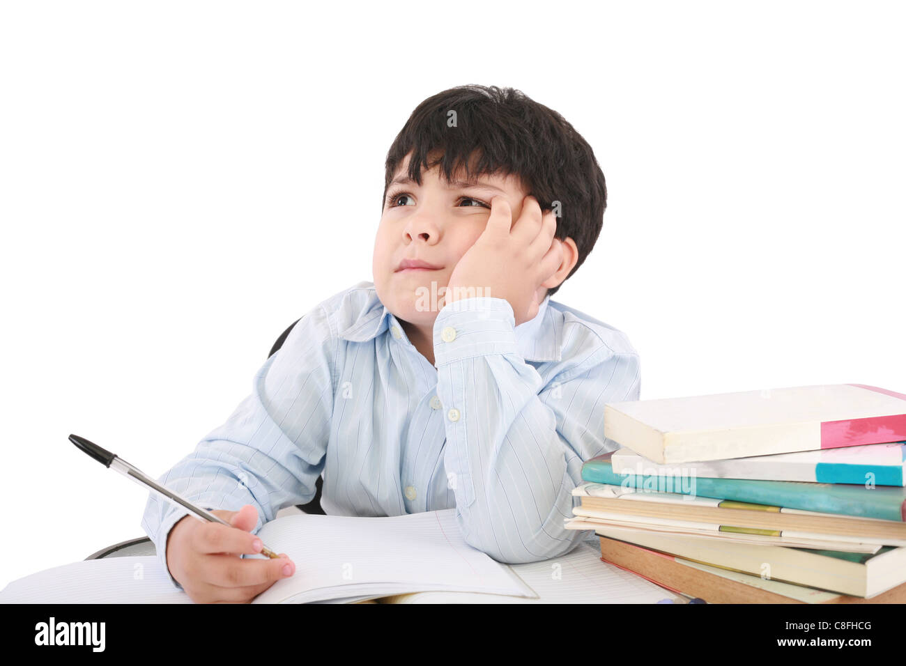 Upset schoolboy doing homework isolated on white Stock Photo - Alamy