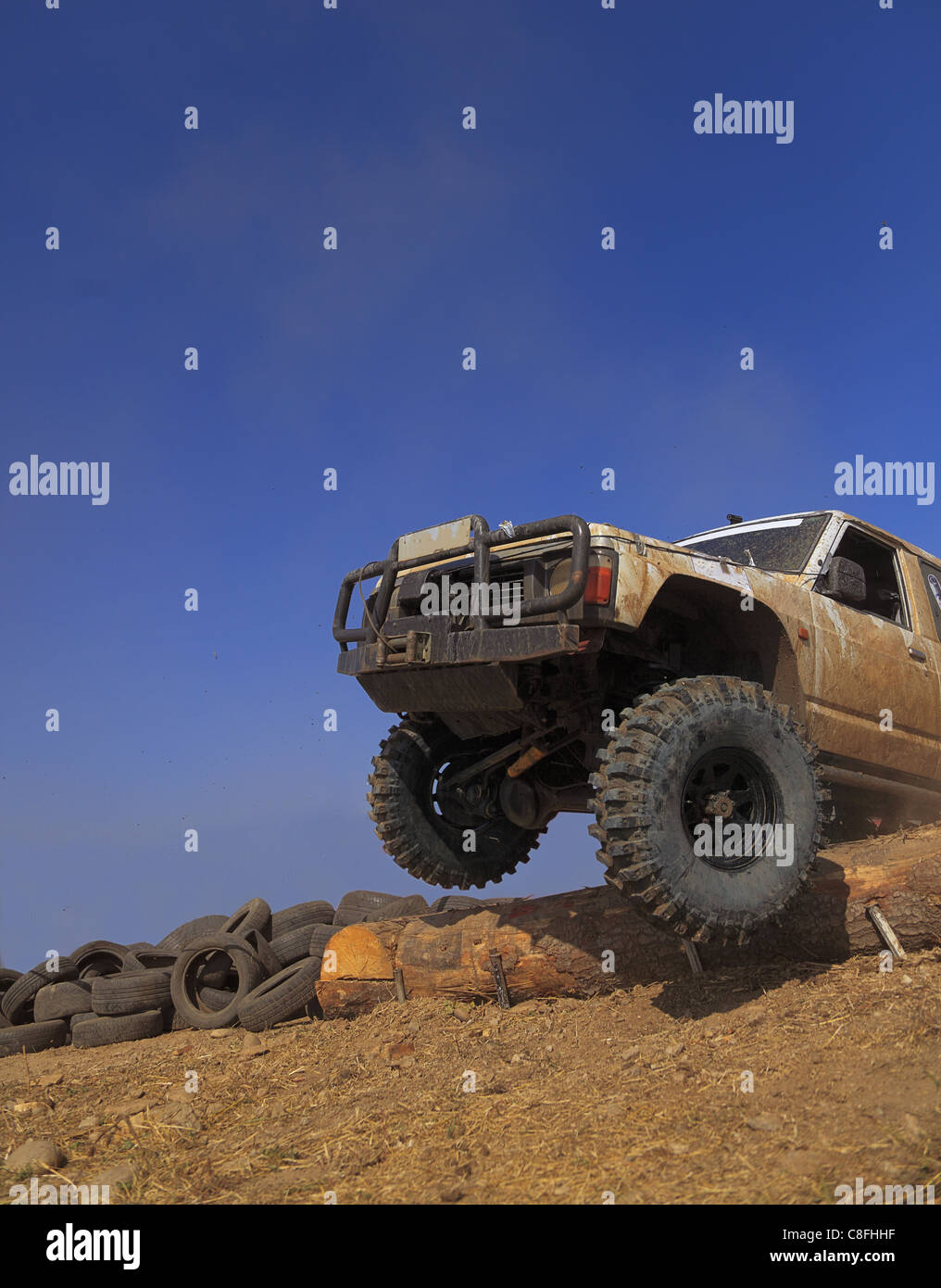 Off road car passing a tree trunk obstacle during a competition Stock ...