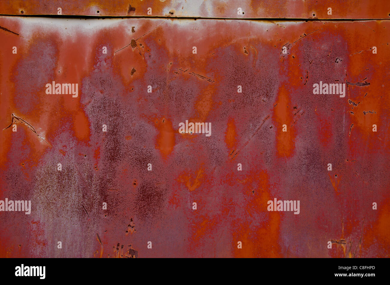 Rusty red painted wall made of tin. Neglected architectural bacground ...