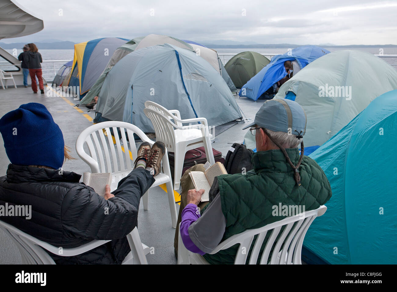 Couple reading a book. Columbia ferry. Alaska Inside Passage. USA Stock ...