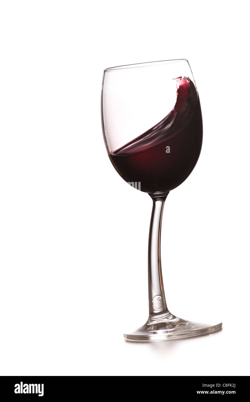 Red wine sloshing in a glass Stock Photo - Alamy
