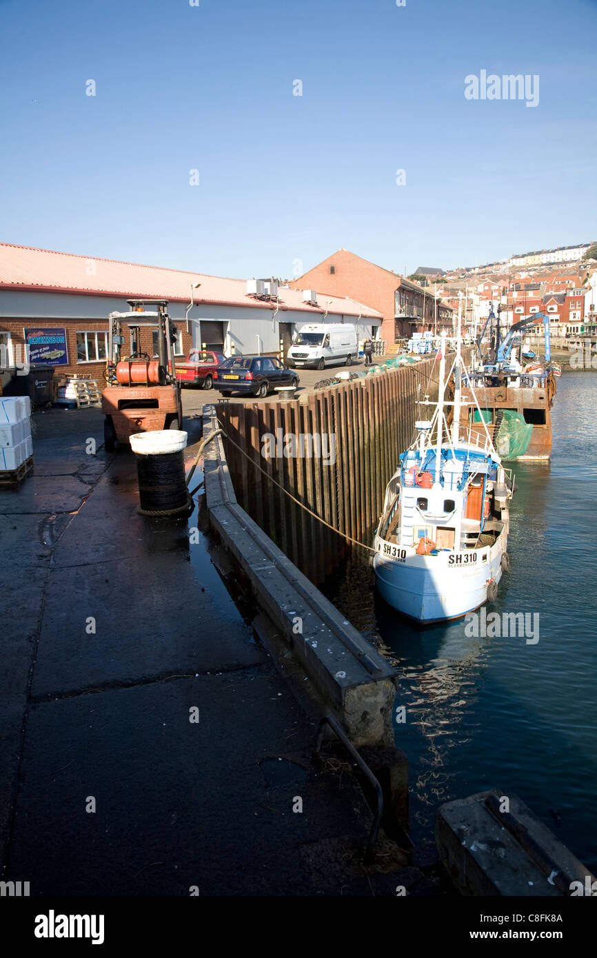 Fishing boats and sheds by the harbour, Scarborough, Yorkshire, England ...