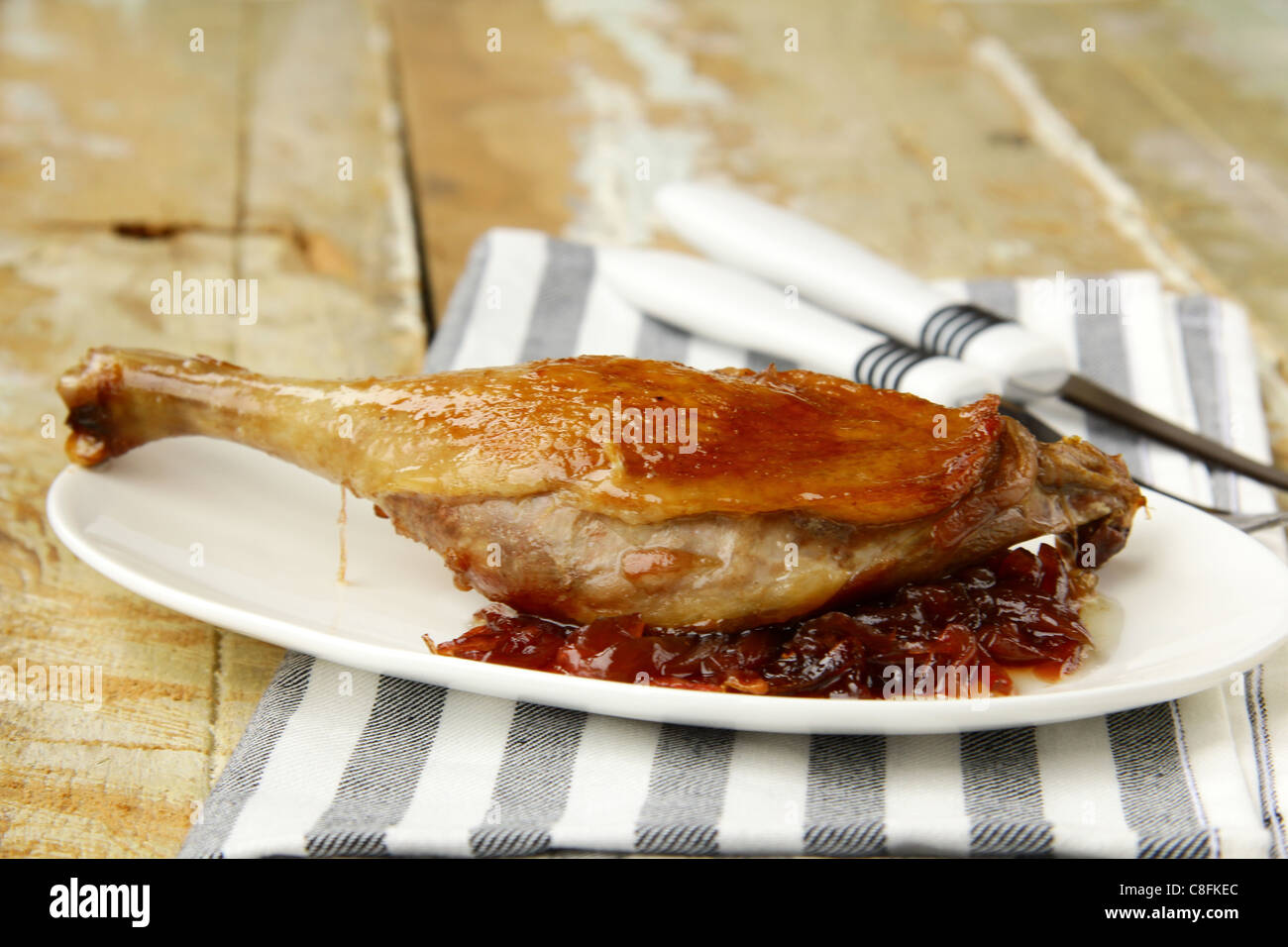 Roasted duck leg on white plate Stock Photo - Alamy