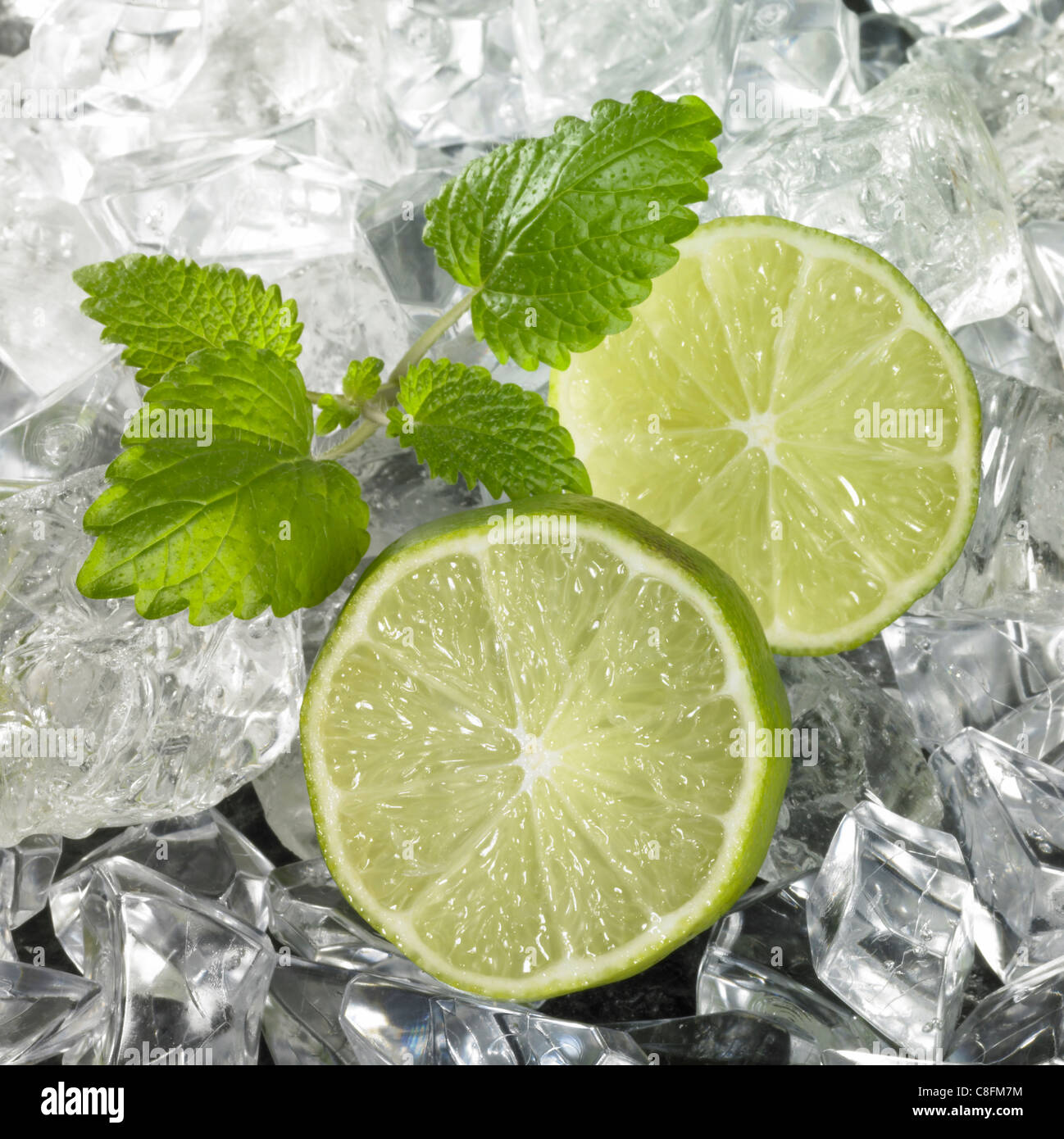 studio photography of some sliced lemon fruits and lots of ice cubes ...