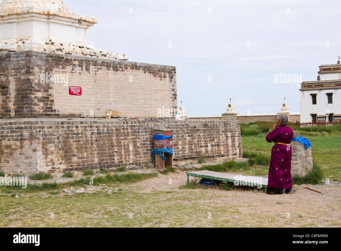 Elderly nomadic woman in Karakorum prepares to pray at the Erdene Zuu ...
