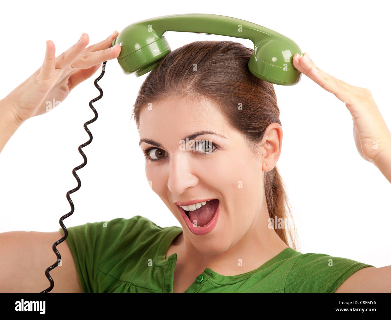 Beautiful woman doing funny faces with a vintage green telephone Stock ...