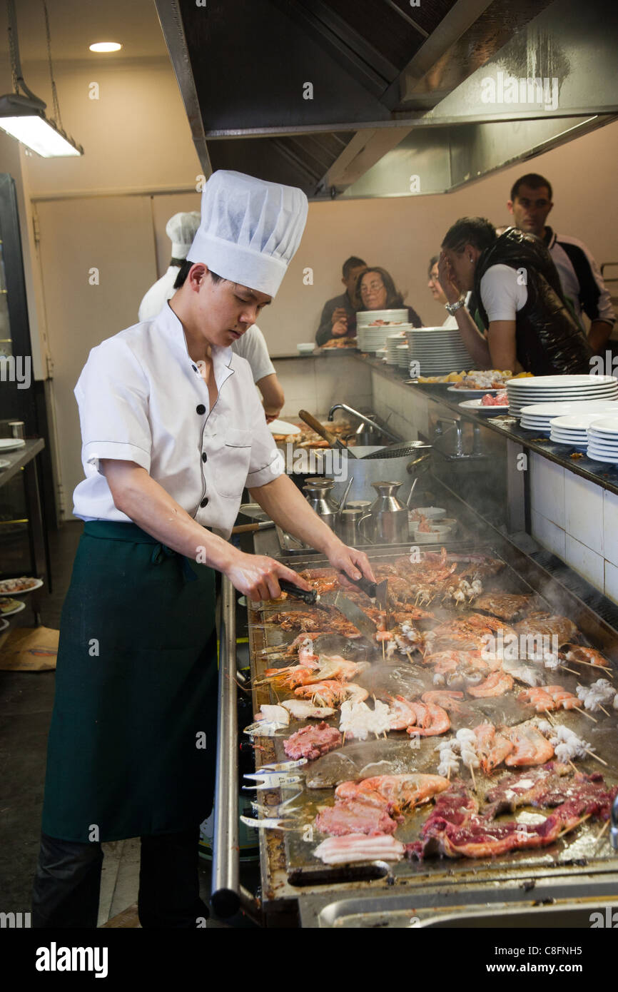 Chinese chef cooking food on grill in a chinese restaurant in Rome ...