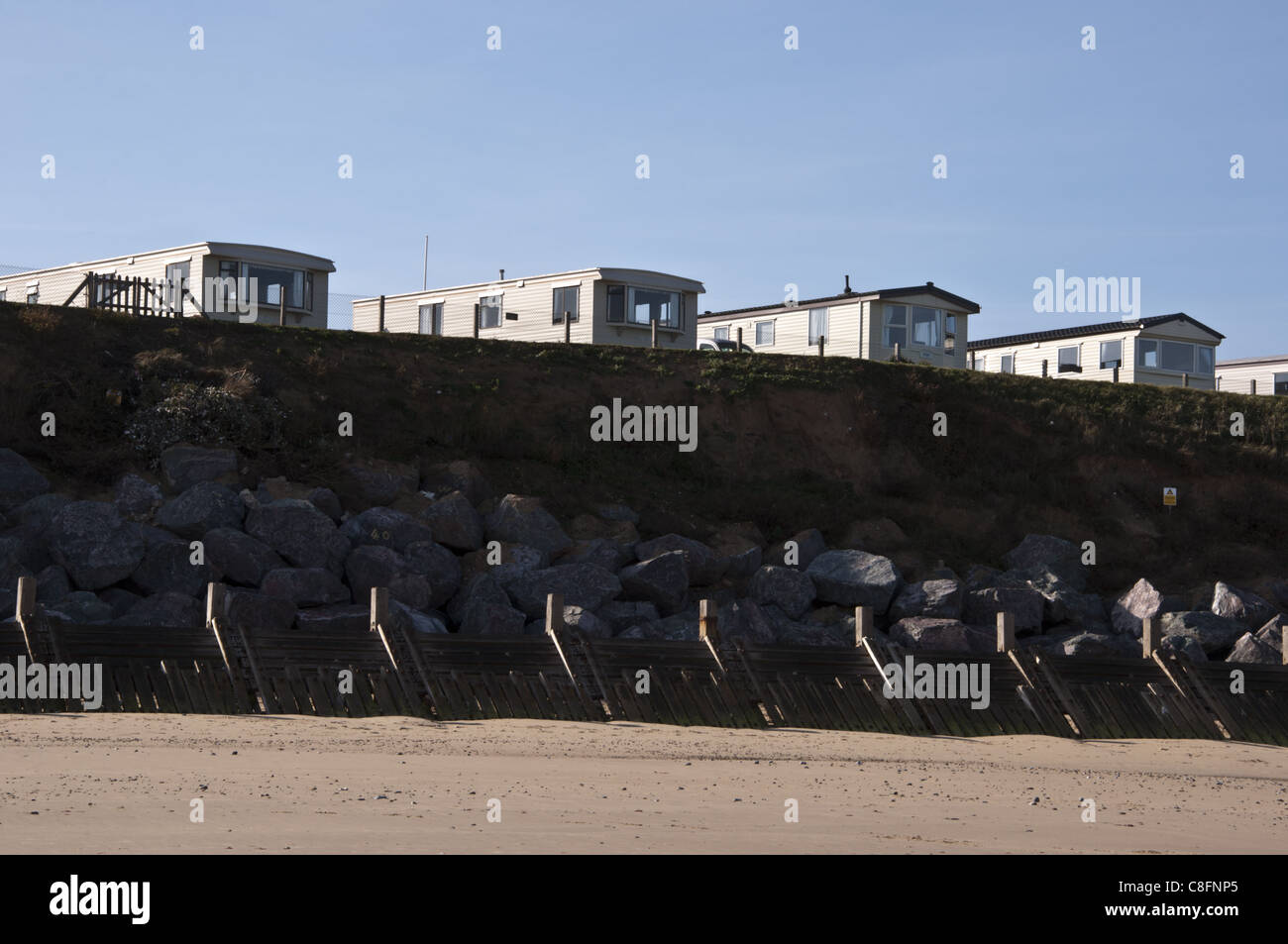 static caravan behind concrete sea wall defences Bacton Norfolk Stock ...
