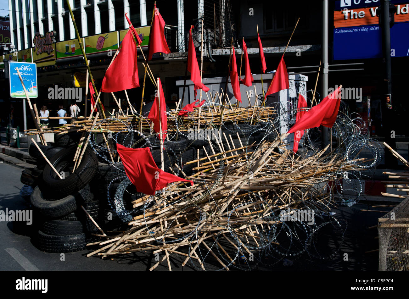 Red flags fly above Barricade made of tires, bobwire, & sharpened ...